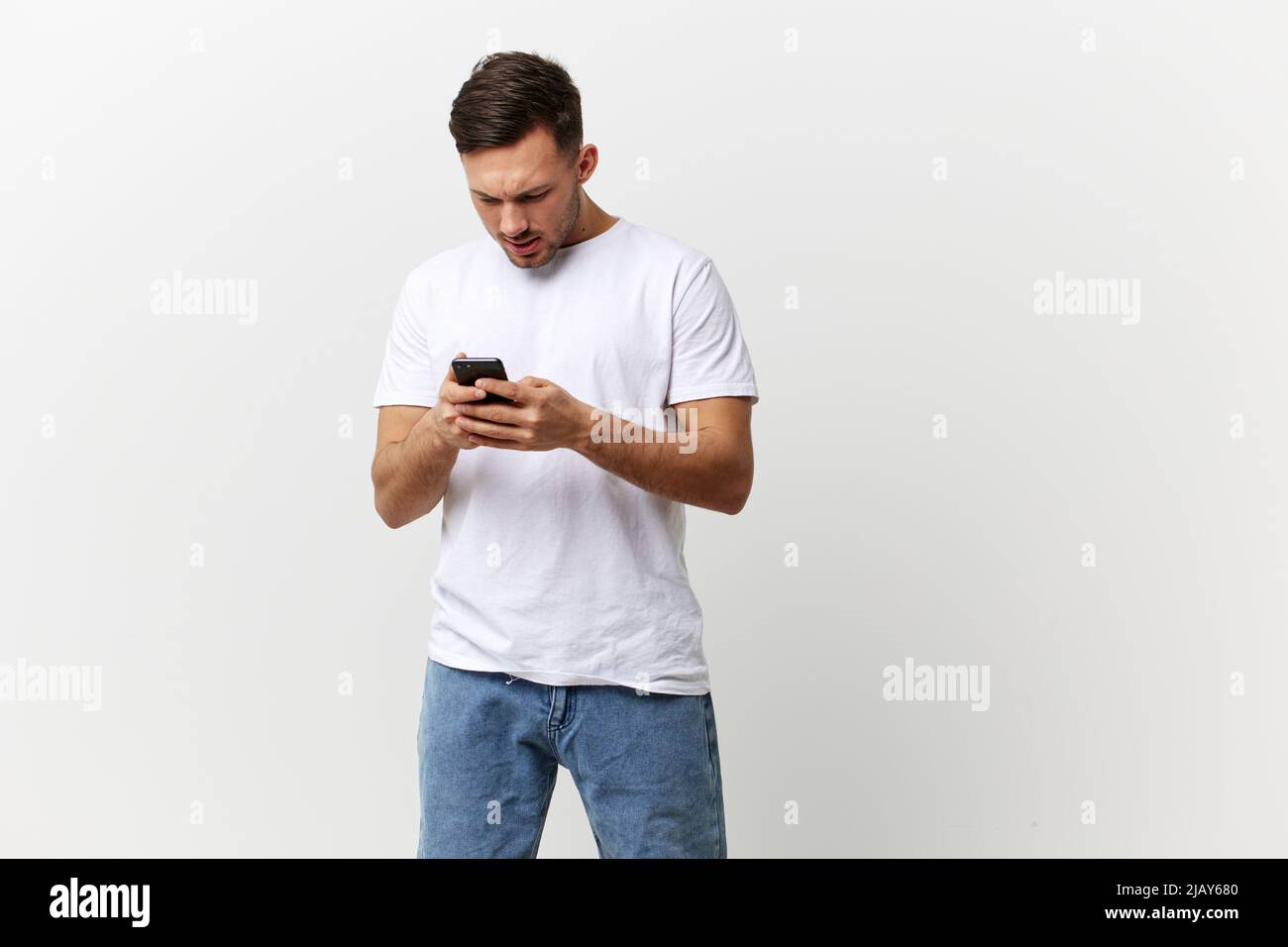 Angry confused irritated tanned handsome man in basic t-shirt type ...