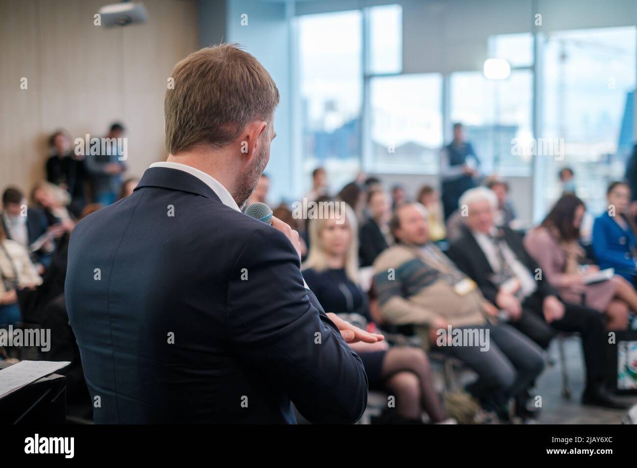 Business speaker talking to audience Stock Photo - Alamy