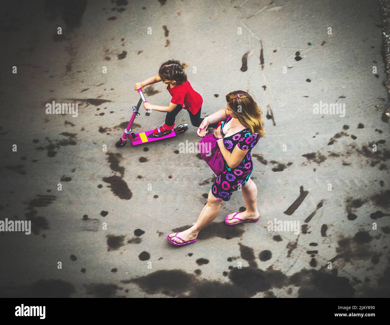 mother and daughter walk along dirty asphalt, above view Stock Photo ...
