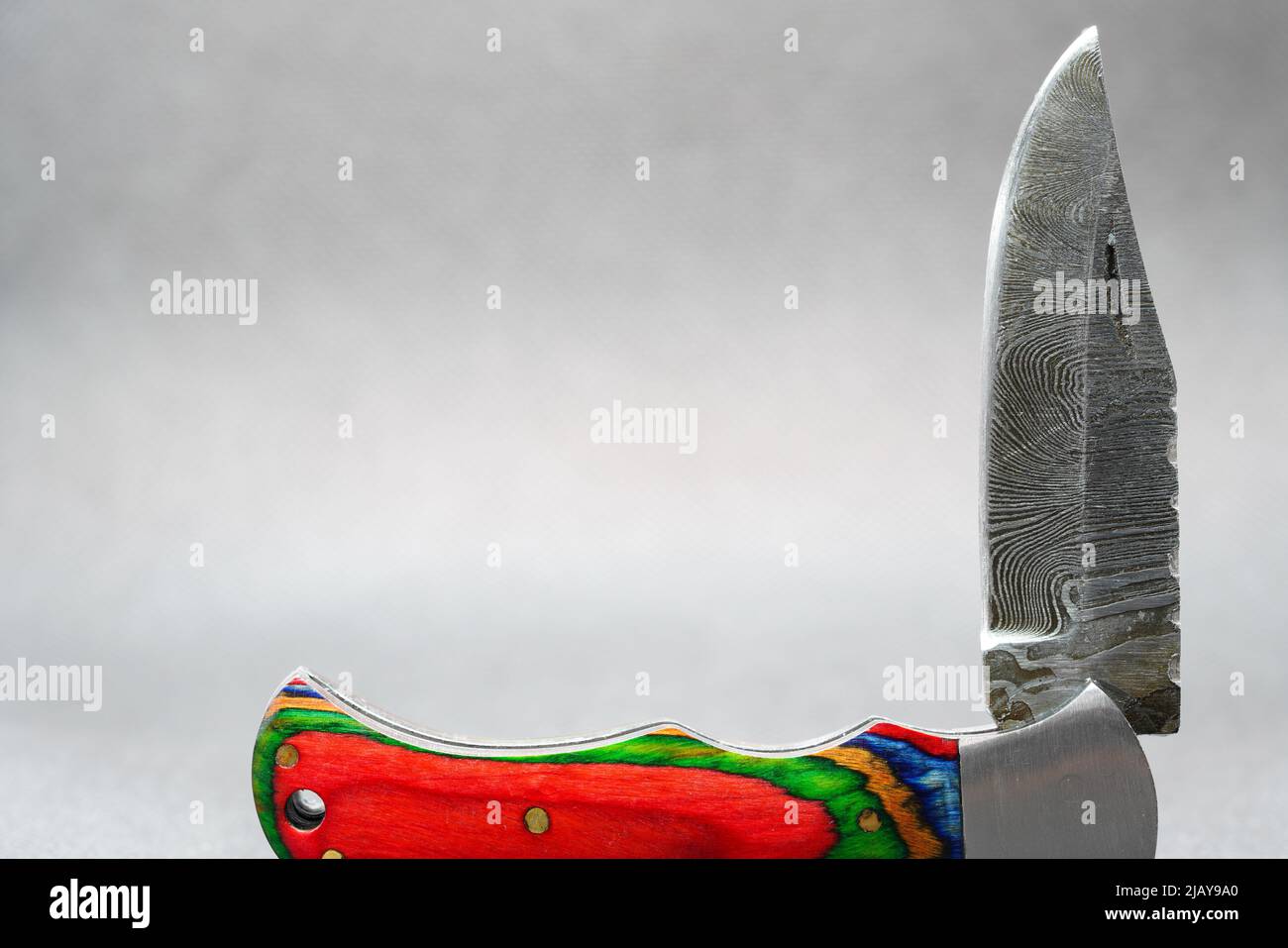 Hand-forged knife made of several layers of steel with an exclusive ...