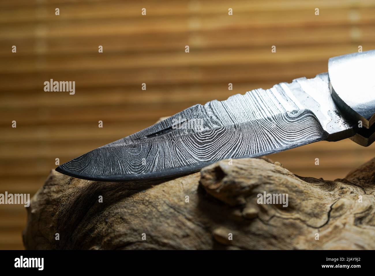 Hand-forged knife made of several layers of steel with an exclusive ...