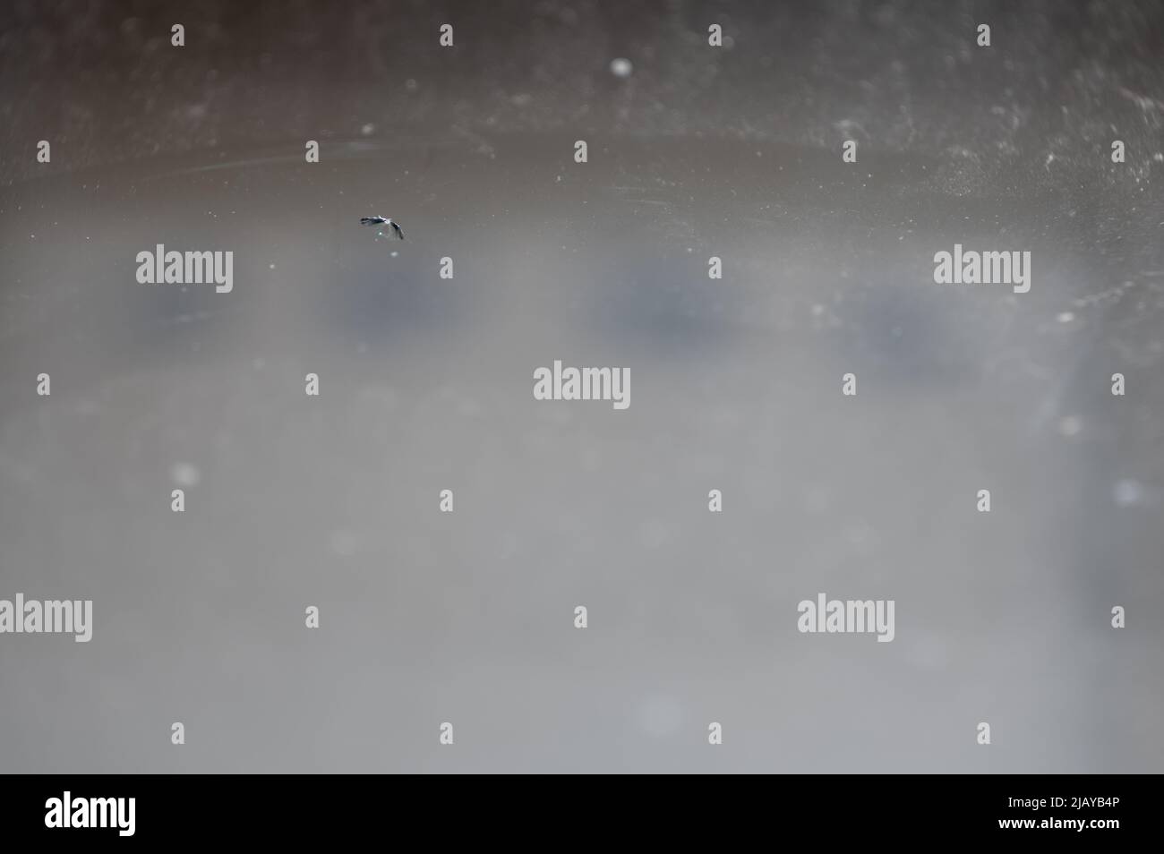 Chip in the glass windshield of a vehicle Stock Photo - Alamy