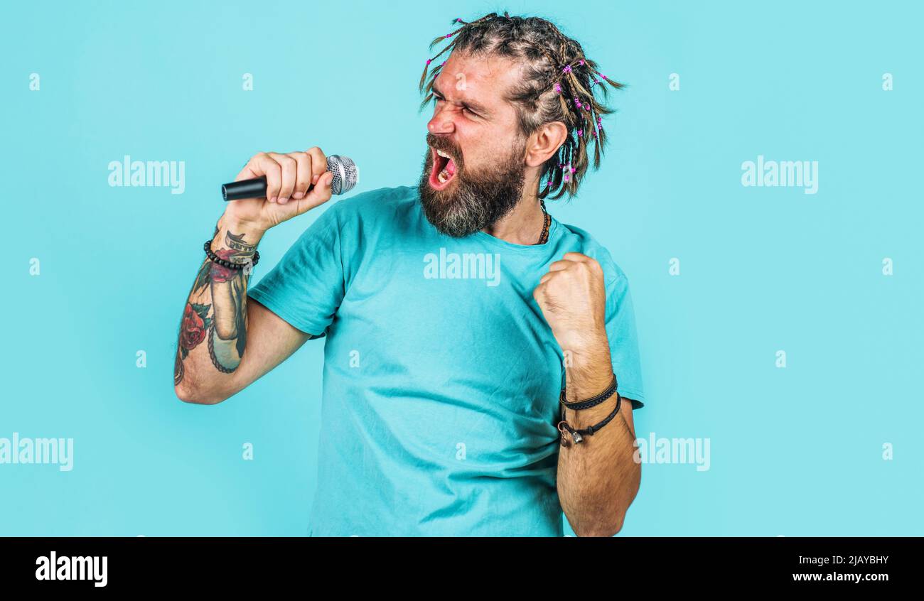 Karaoke. Bearded man singing in microphone. Emotional singer with ...