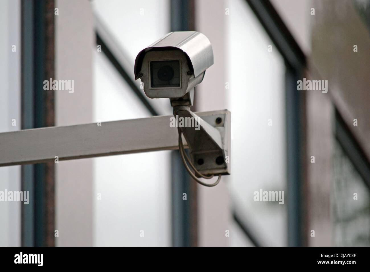 CCTV - security camera, office building in background Stock Photo - Alamy
