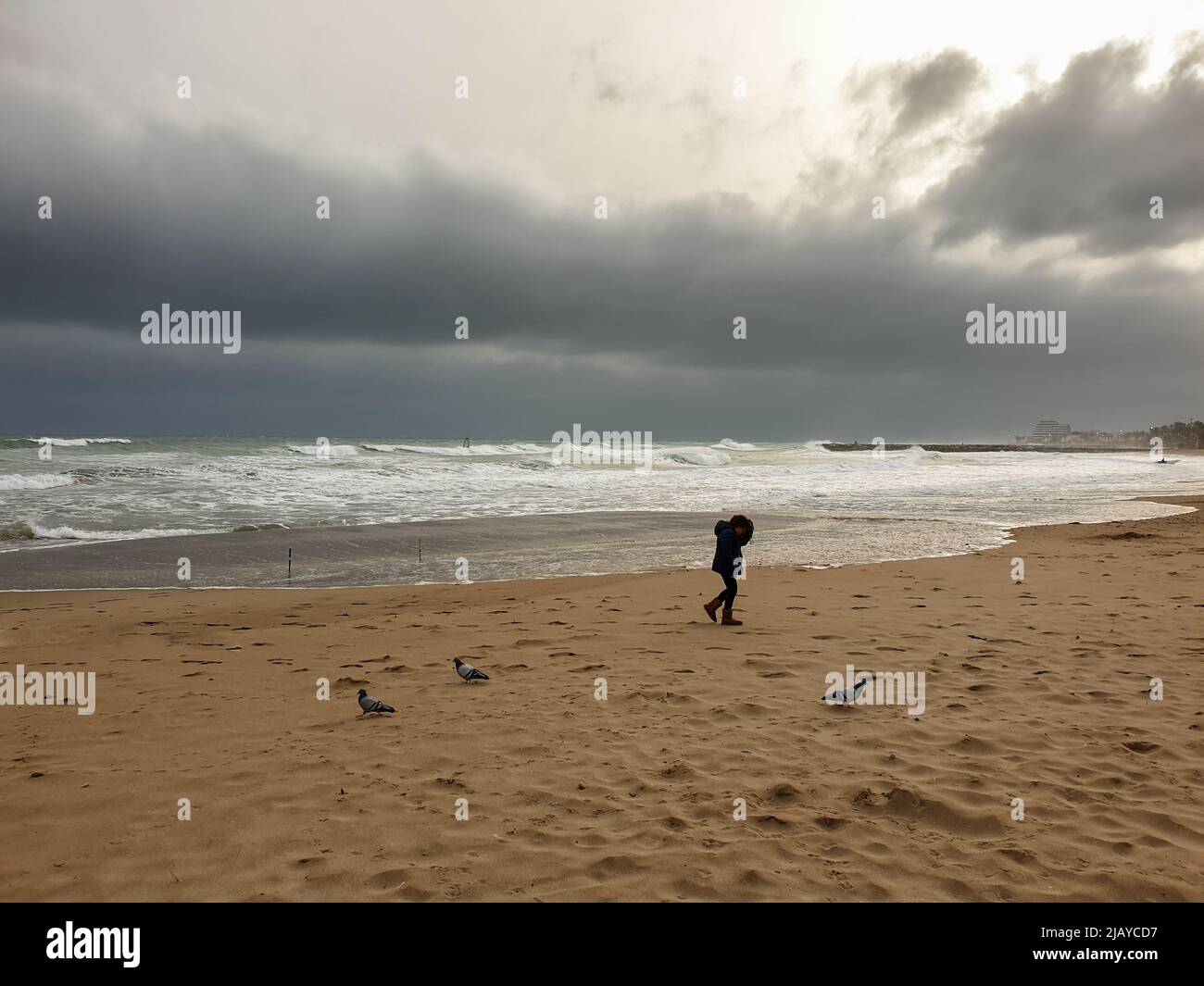 Windy day on the sand beach at Sitges, dramatic sky with wavy sea Stock ...