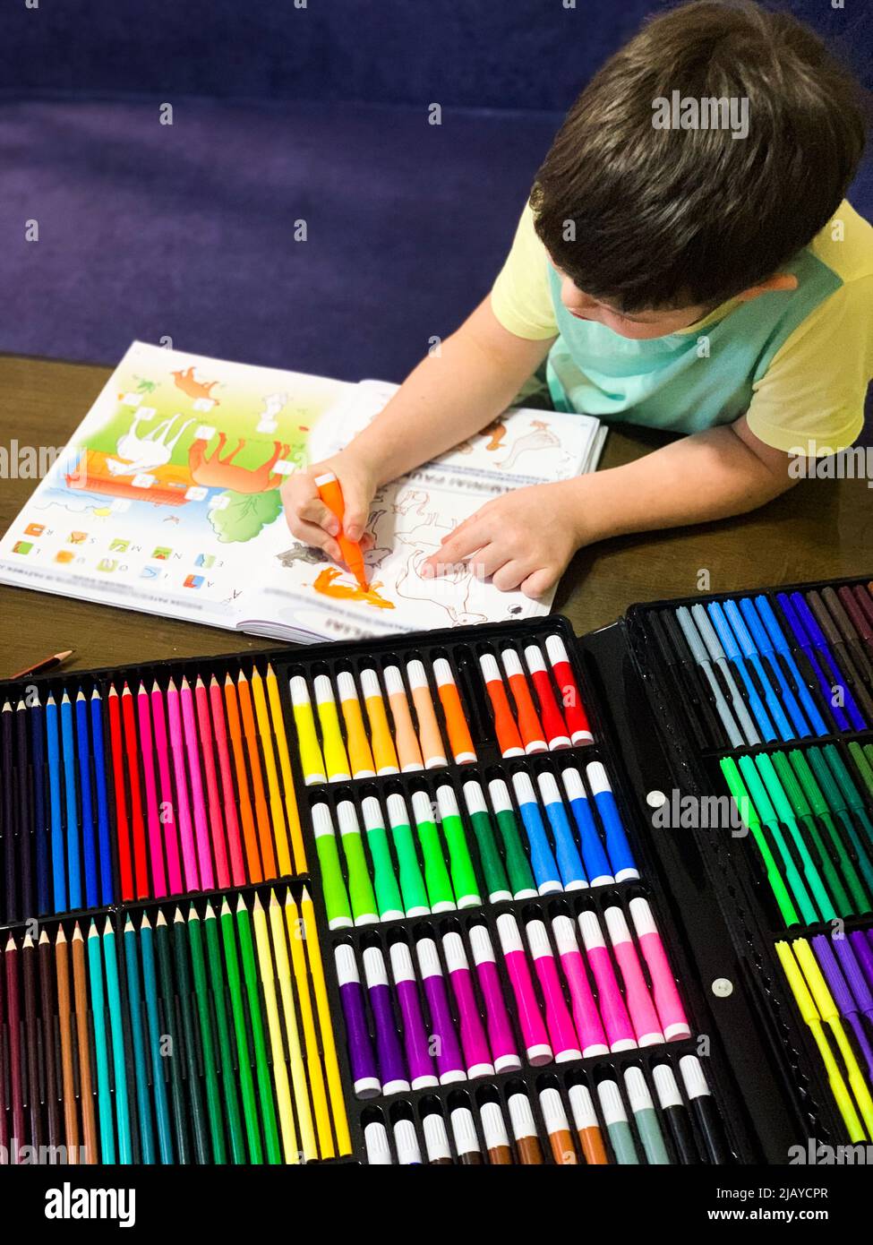 Little boy coloring in book with colorful markers, felt tip pens Stock ...