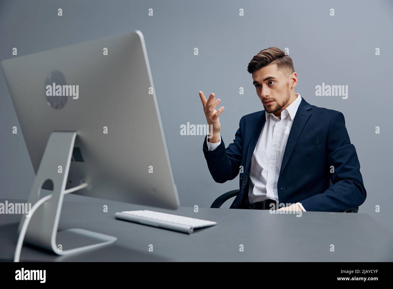 manager sitting at a desk in front of a computer executive Stock Photo ...
