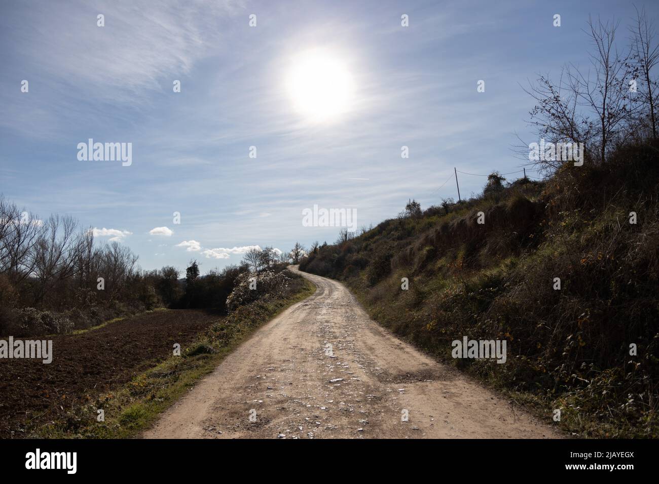 Curved sandy path uphill, sunny day Stock Photo - Alamy