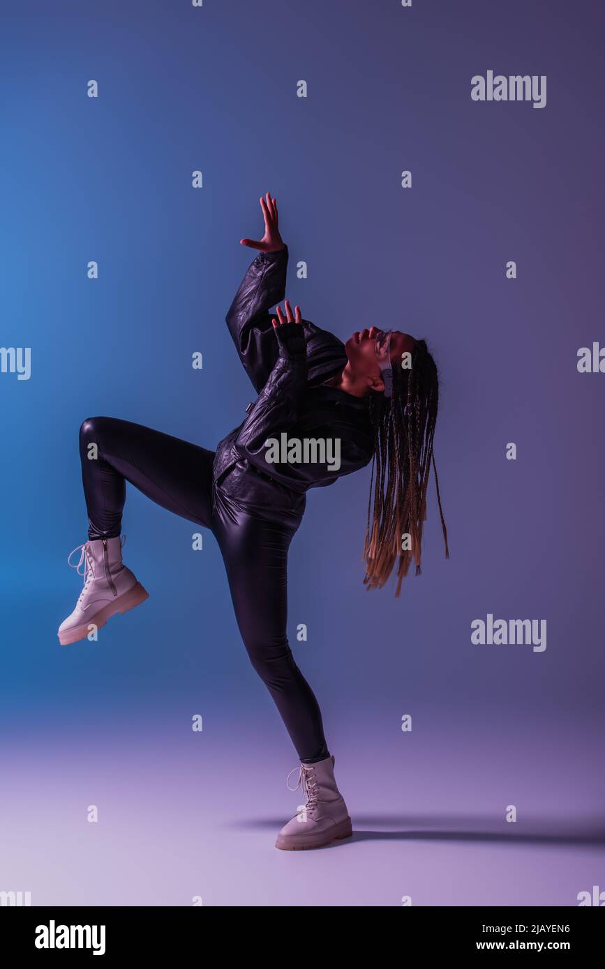African american woman in smart glasses and leather jacket posing on ...
