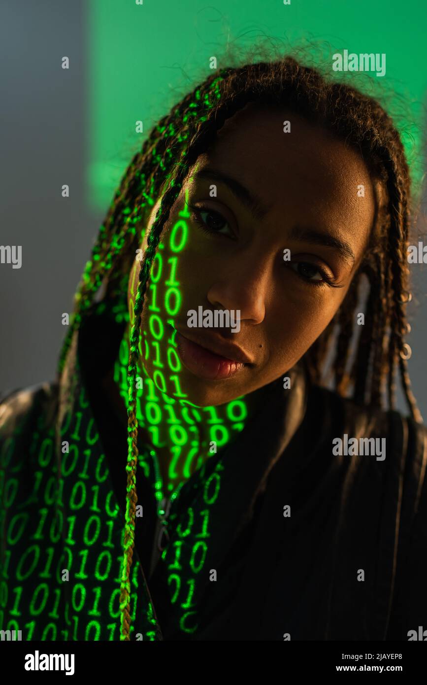 Portrait of african american woman with binary code on face on grey ...