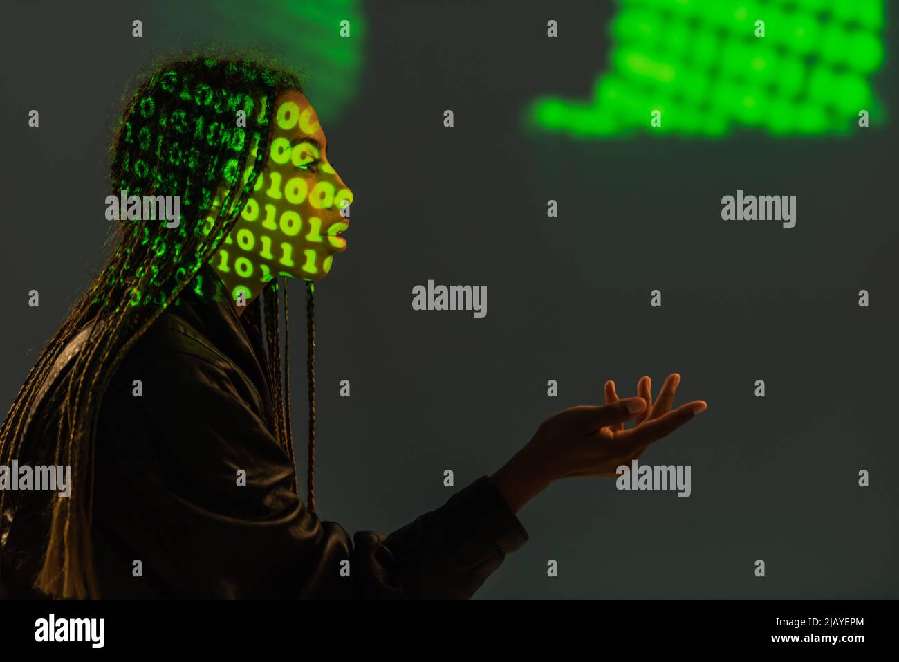 Side view of african american woman with binary code on face on grey ...