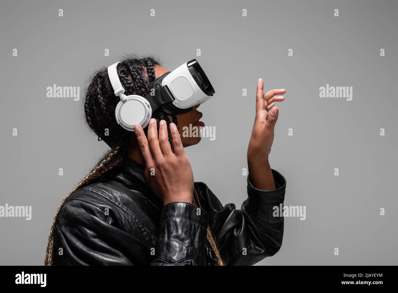 Side view of african american woman in headphones and vr headset ...