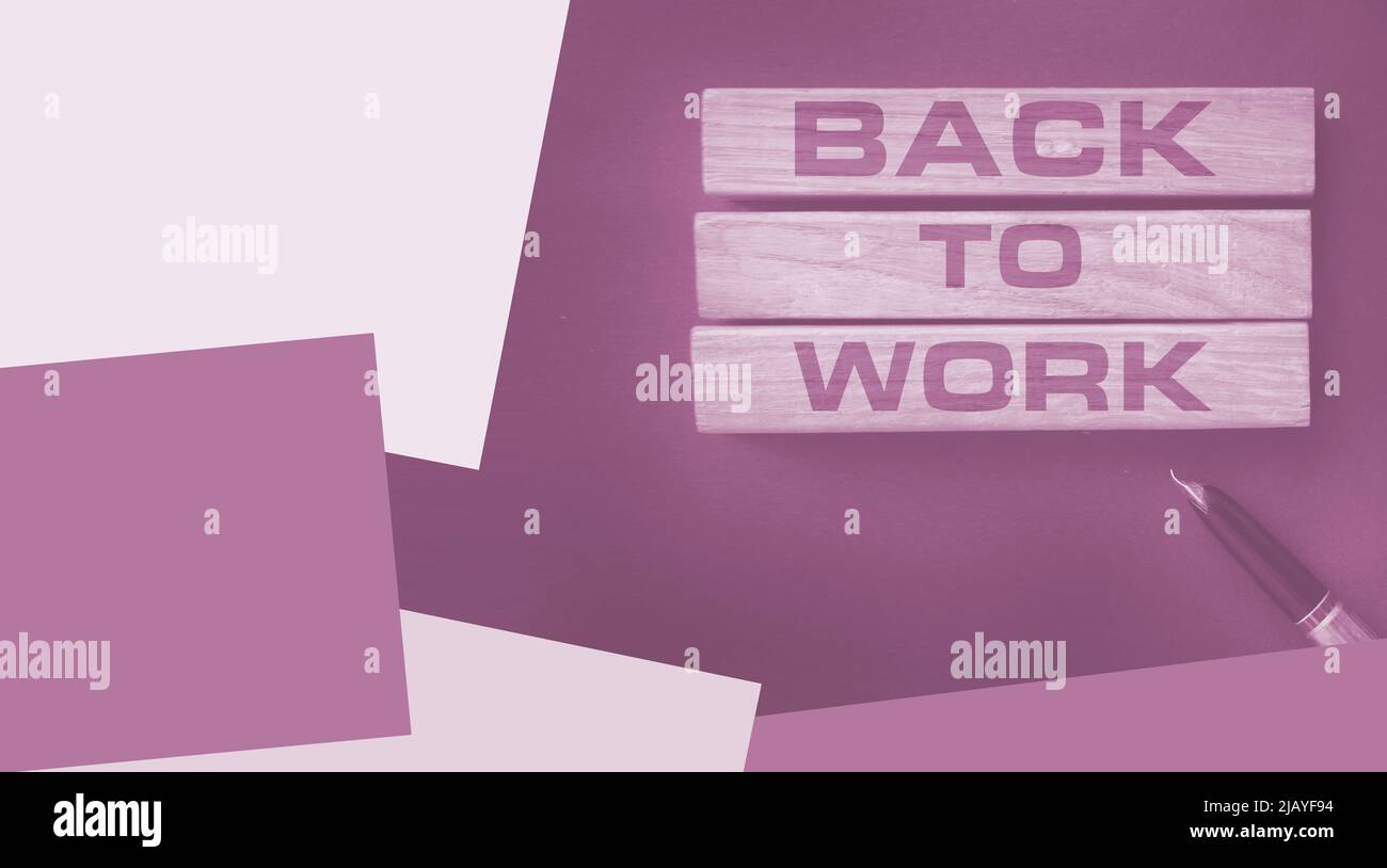 Words back to work written with wooden blocks on black background and ...