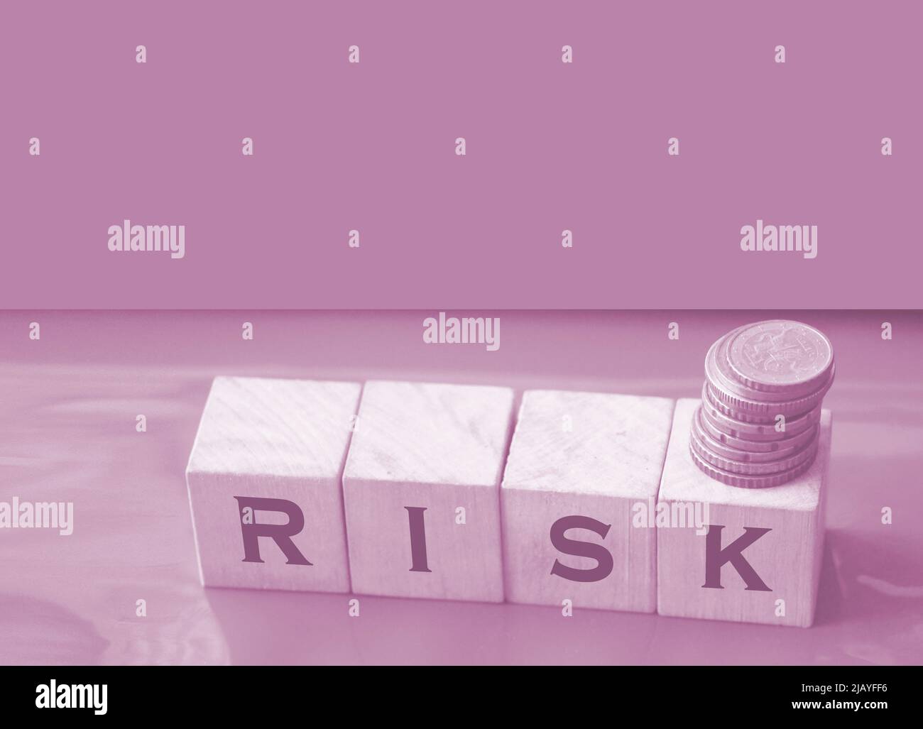 RISK word written on wooden cubes and coins. Financial risk assessment ...