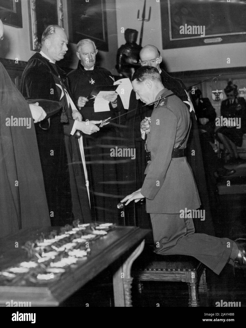 The Duke of Gloucer gives the Accolade of the order of St. John to the ...