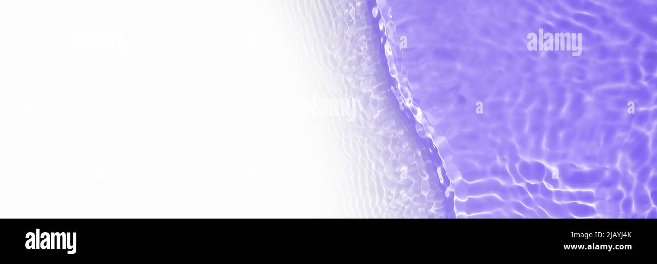 Surface of toned in purple swimming pool water with light reflection ...