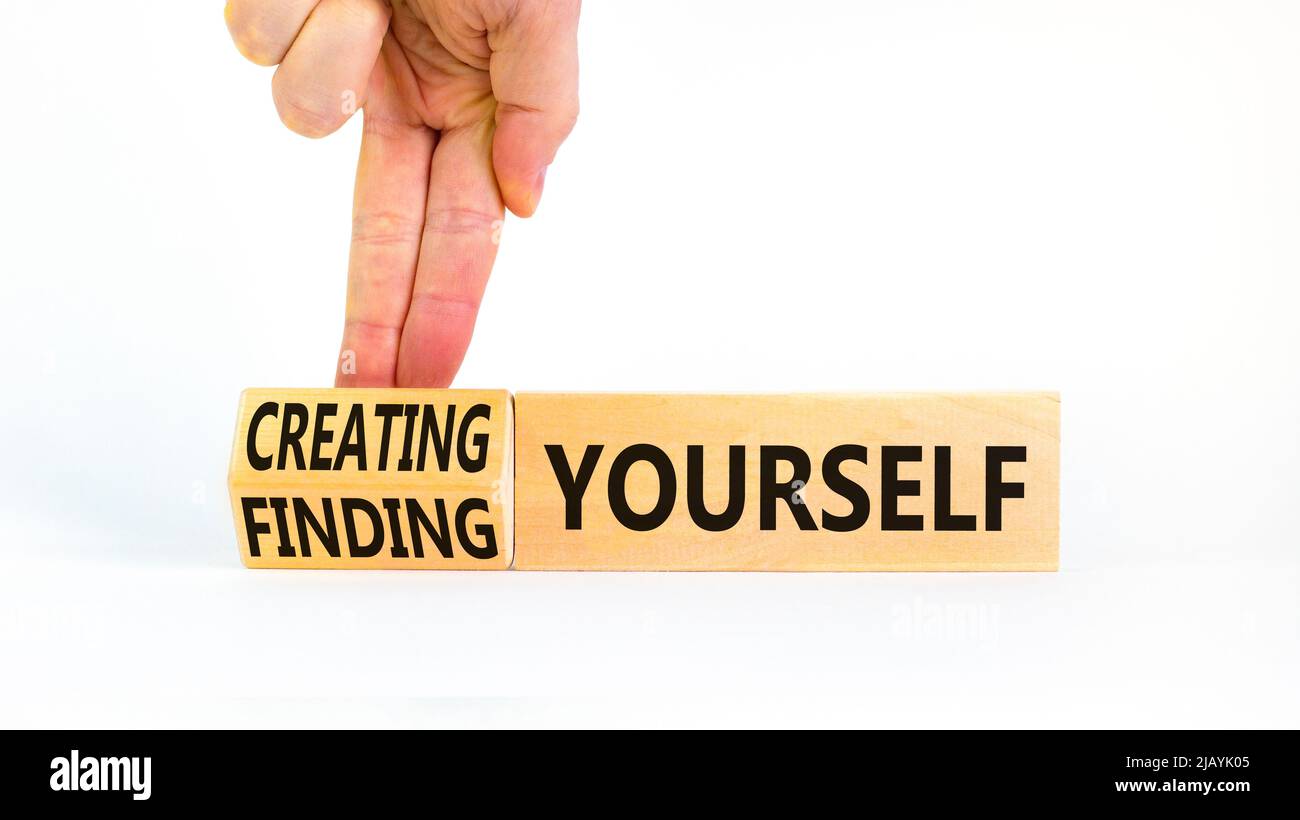 Finding or creating yourself symbol. Businessman turns wooden cubes and ...