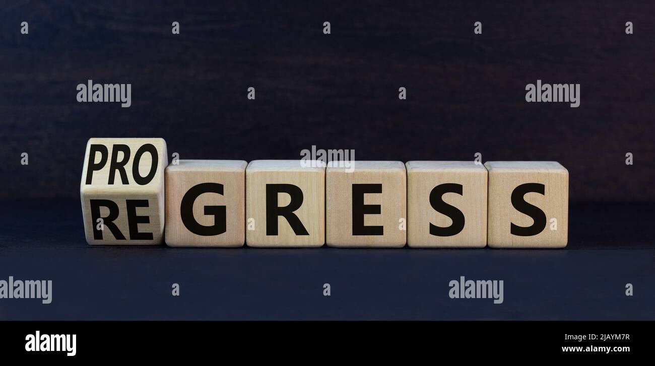 Regress or progress symbol. Turned wooden cubes and changed the word ...
