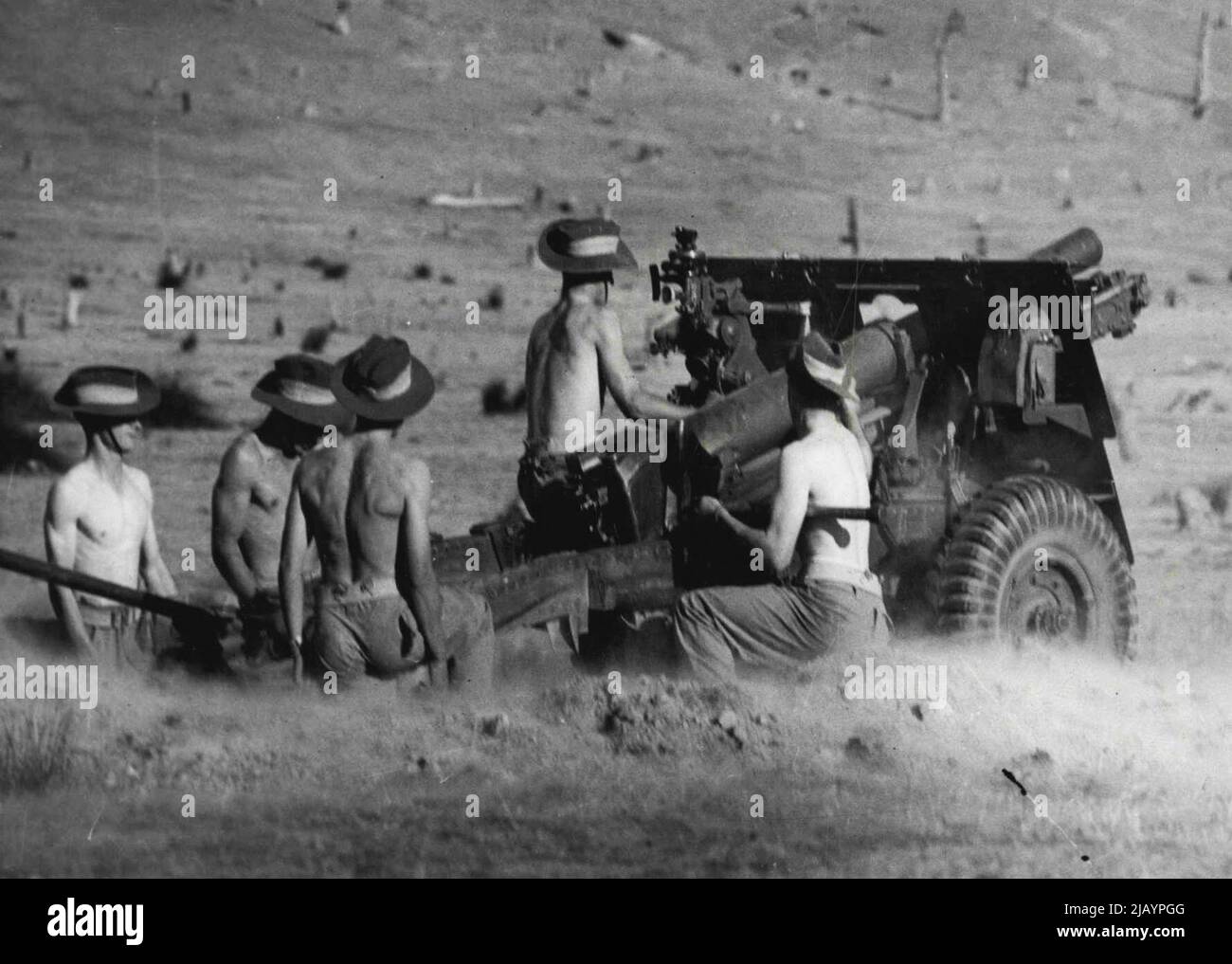 Stripped to the waist, gunners of the 31st Medium battery, CMF, fire ...