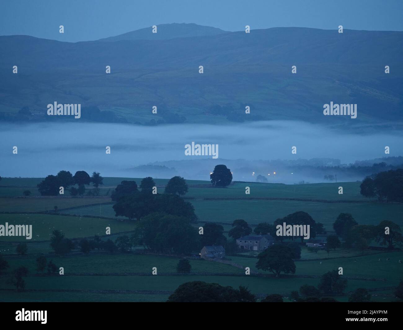 Moody atmospheric landscape image with misty early morning cloud ...