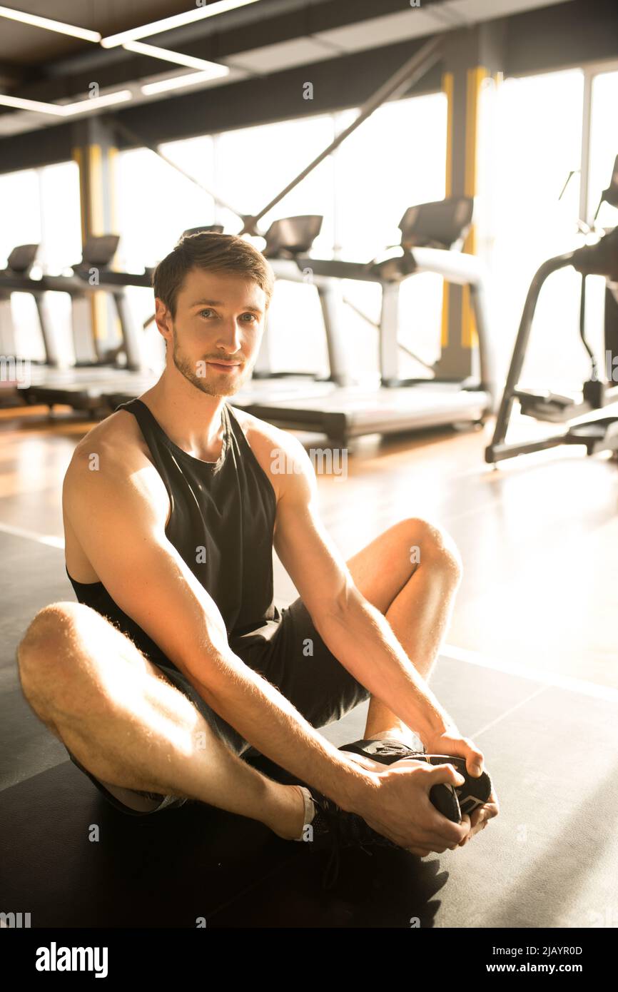 Muscular man sitting on floor hi-res stock photography and images - Alamy