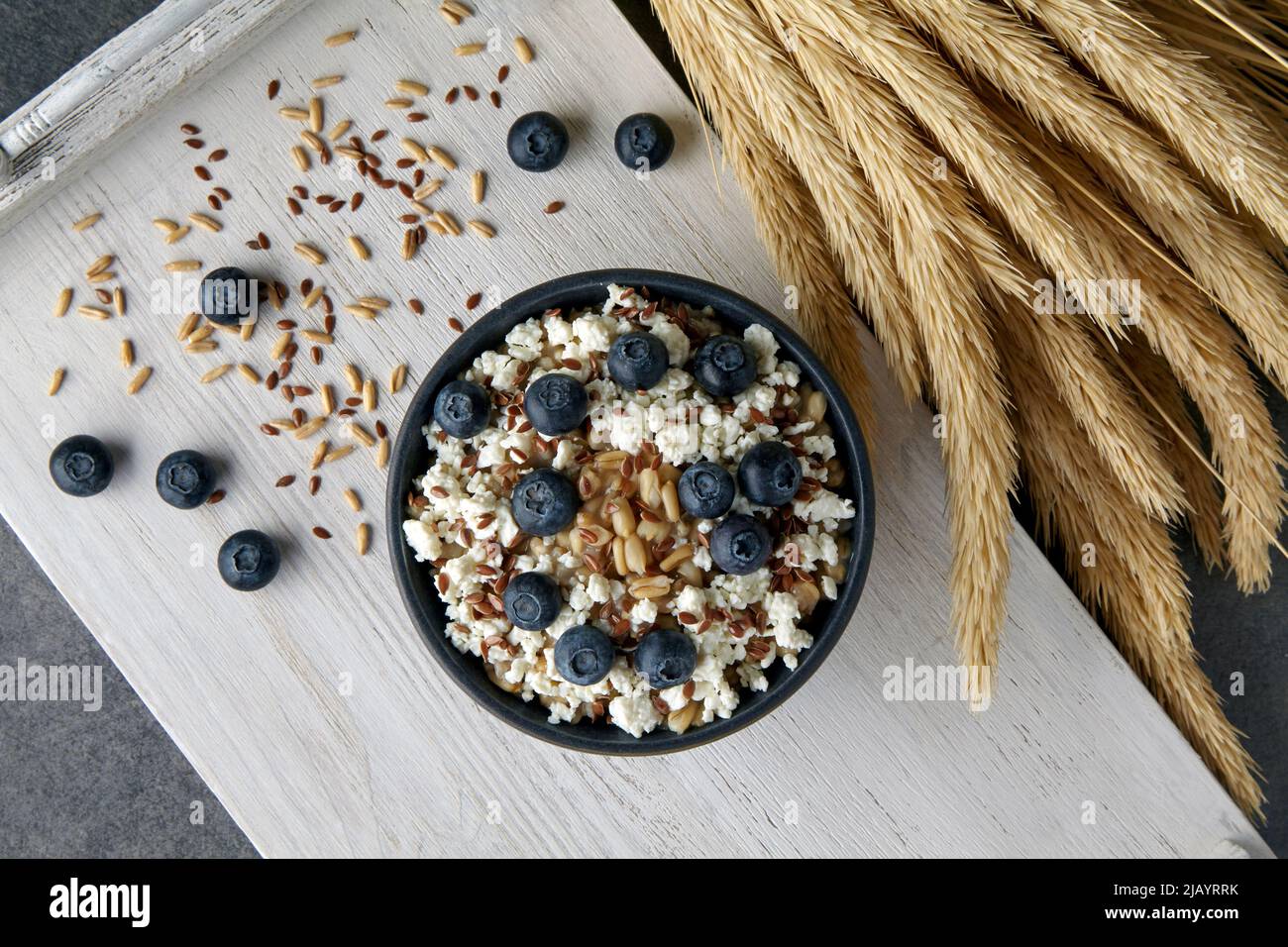 Whole grain oatmeal porridge with flax seeds, blueberries, cottage ...