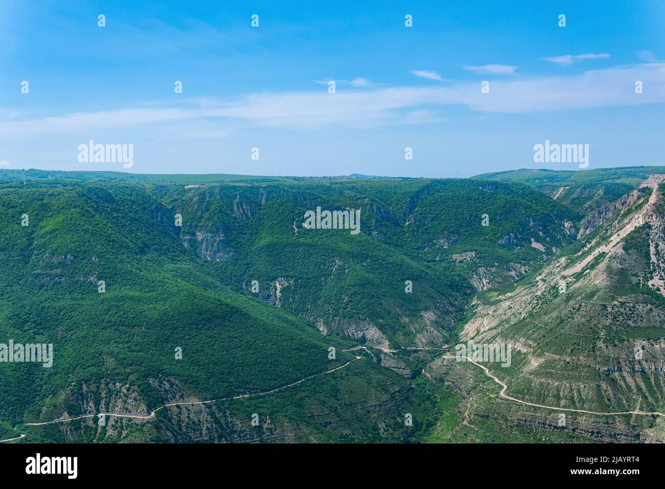 winding road along a wooded mountain slope in a highland area Stock ...