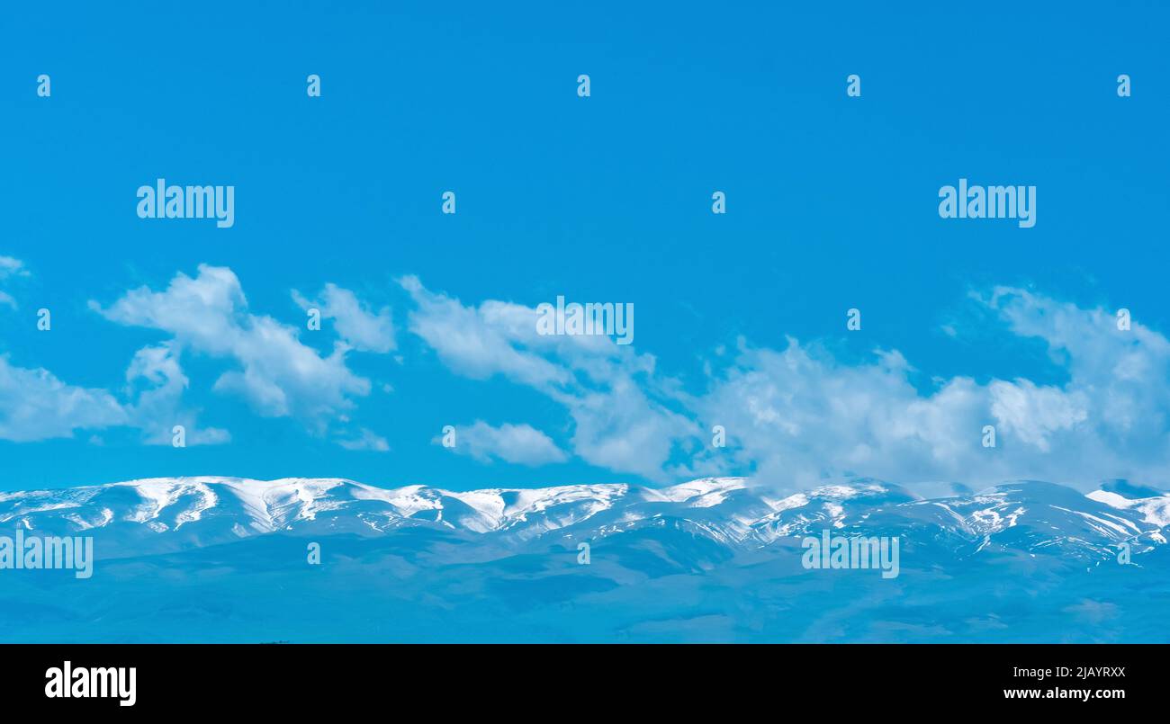 blue mountain sky landscape, snowy peaks of a mountain range in the ...