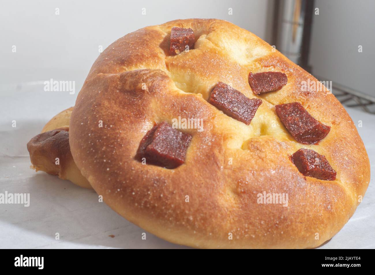 Sweet bread with guava jam and sweet flour on a brown wooden table. It ...