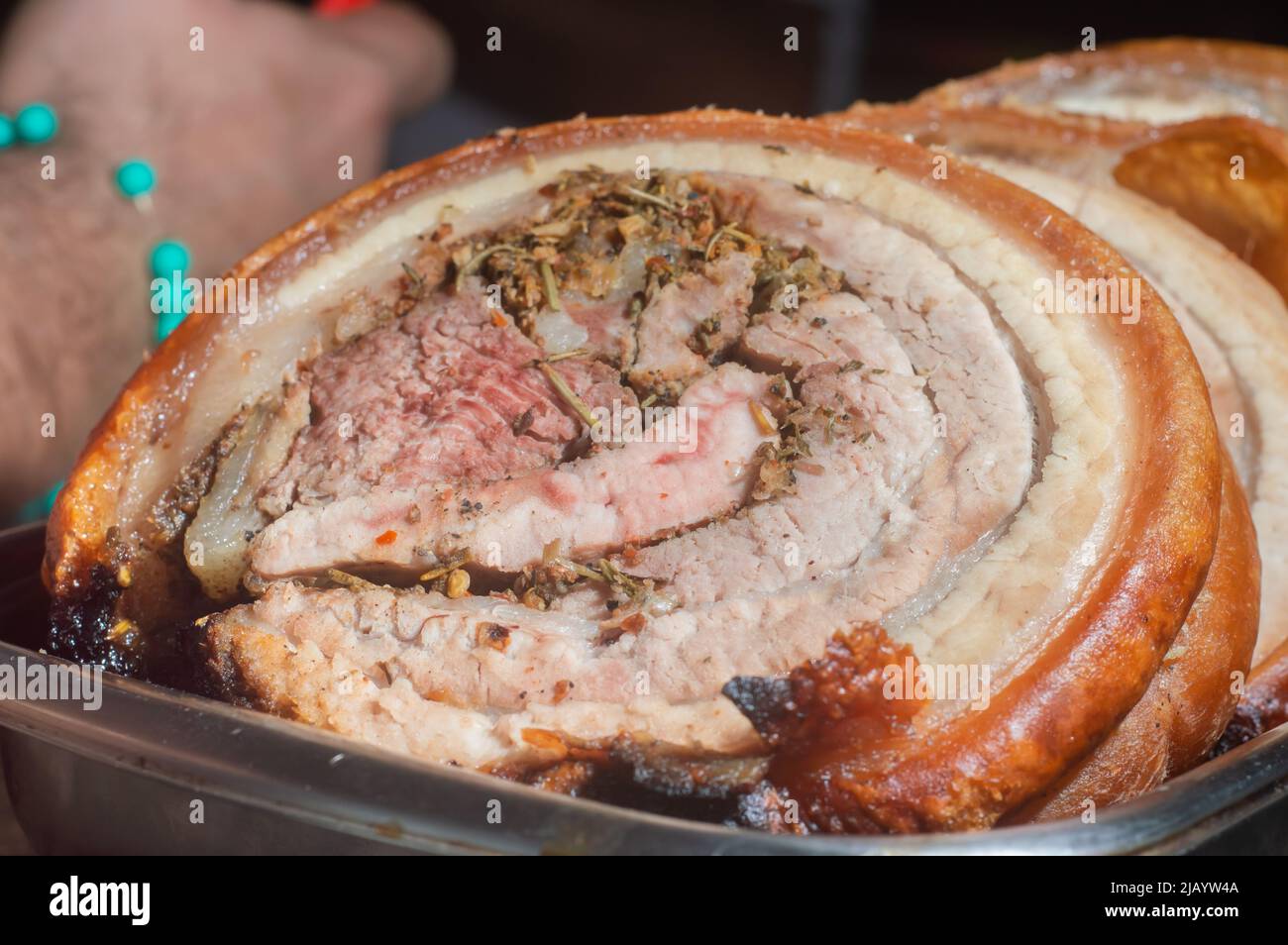 traditional roast of Italian Porchetta, sliced and placed on a metal ...