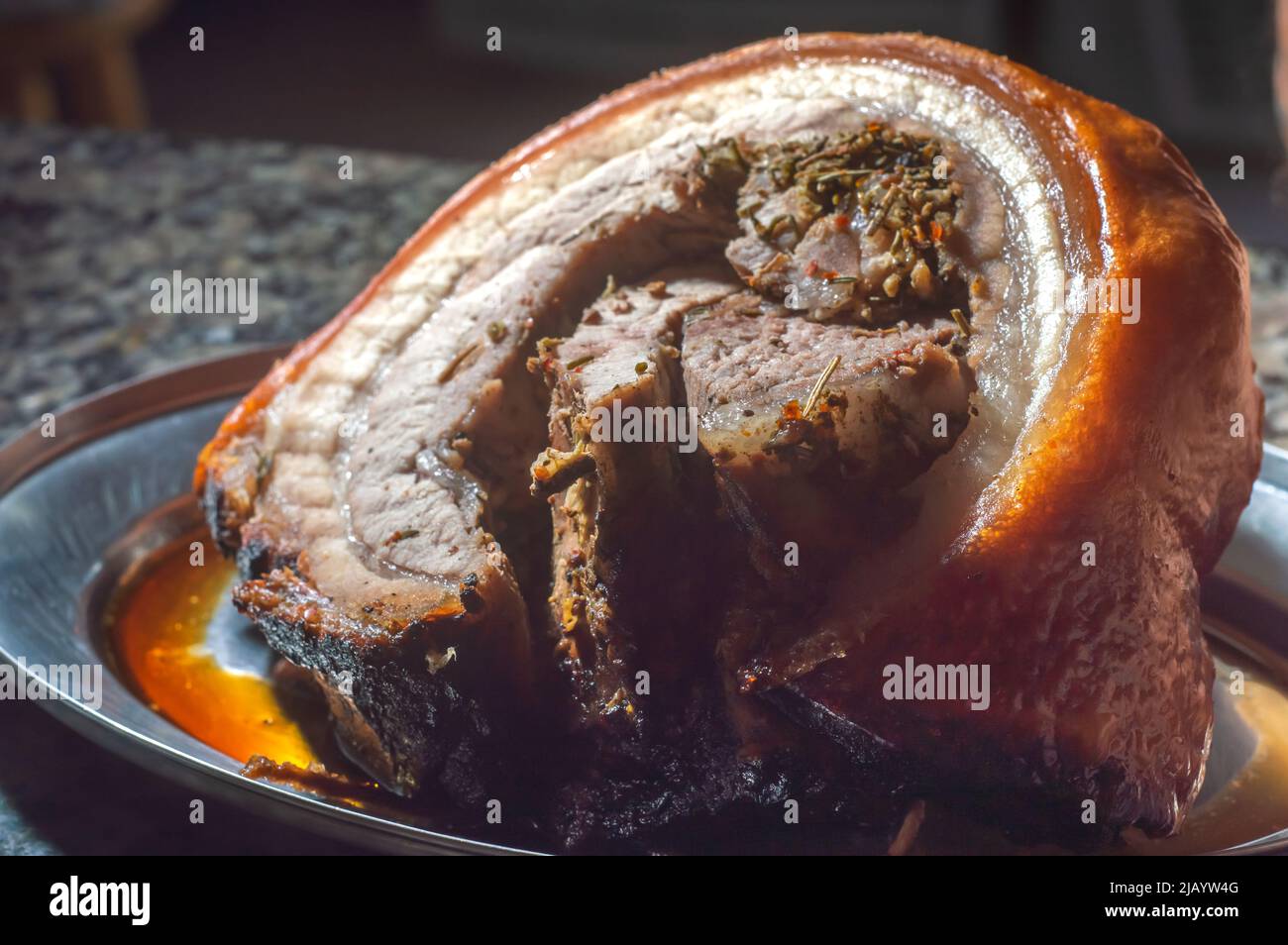 traditional roast of Italian Porchetta, sliced and placed on a metal ...