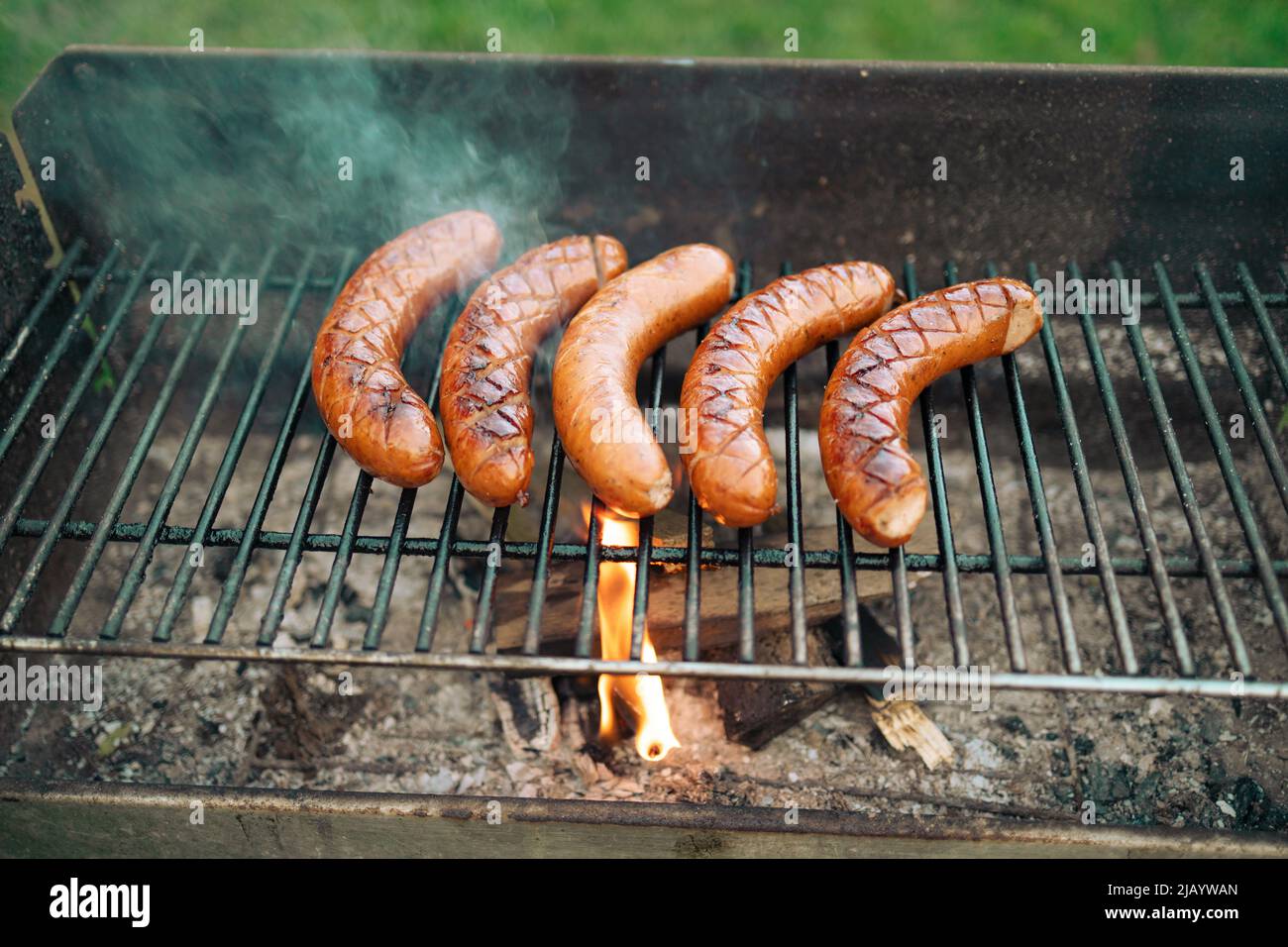 Barbecue grill sausage with fire on open air in the backyard Stock ...