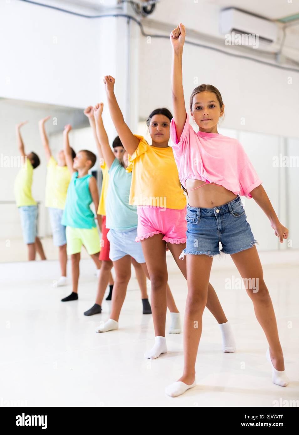 Group of children rehearsing movements of ballet in classroom Stock ...