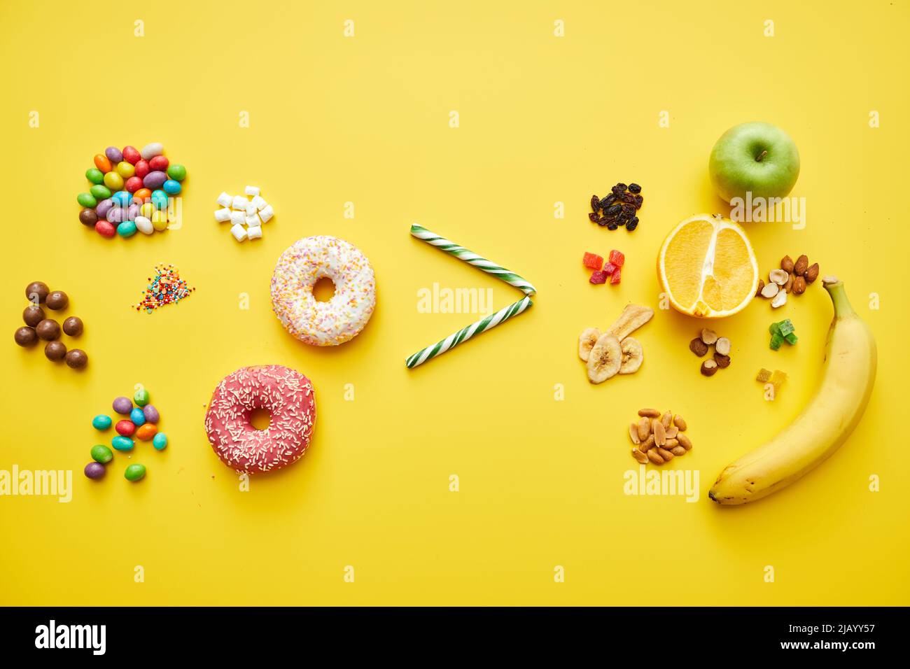 Comparing candies and fruits: greater-than sign between heap of various ...