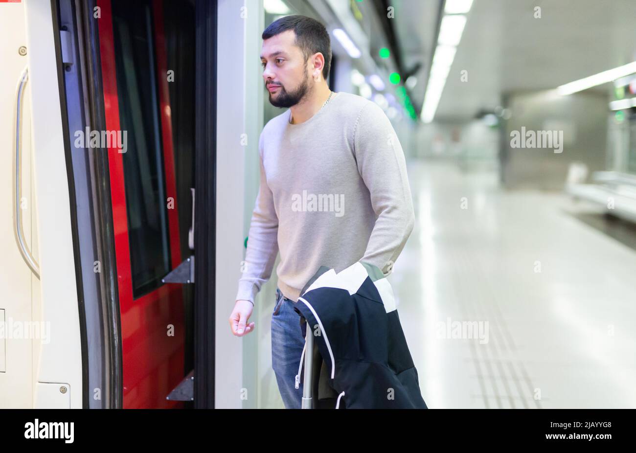 Bearded guy getting into subway train at station Stock Photo - Alamy