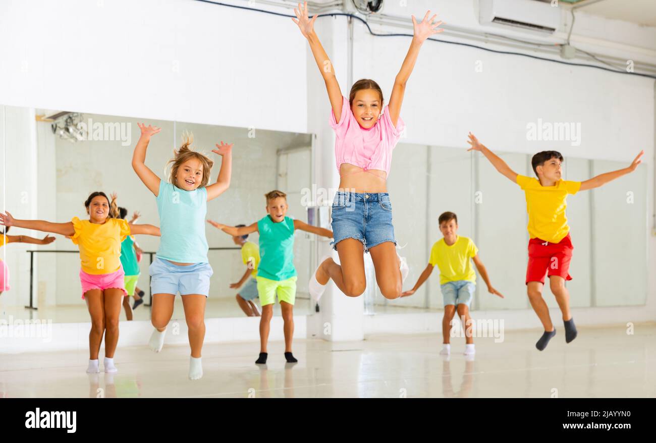 Group of cheerful tweens jumping during dances class Stock Photo - Alamy