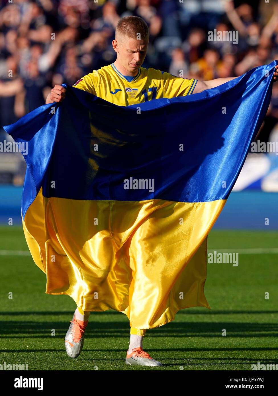 Ukraines Oleksandr Zinchenko Holds Up The Ukraine Flag On The Pitch