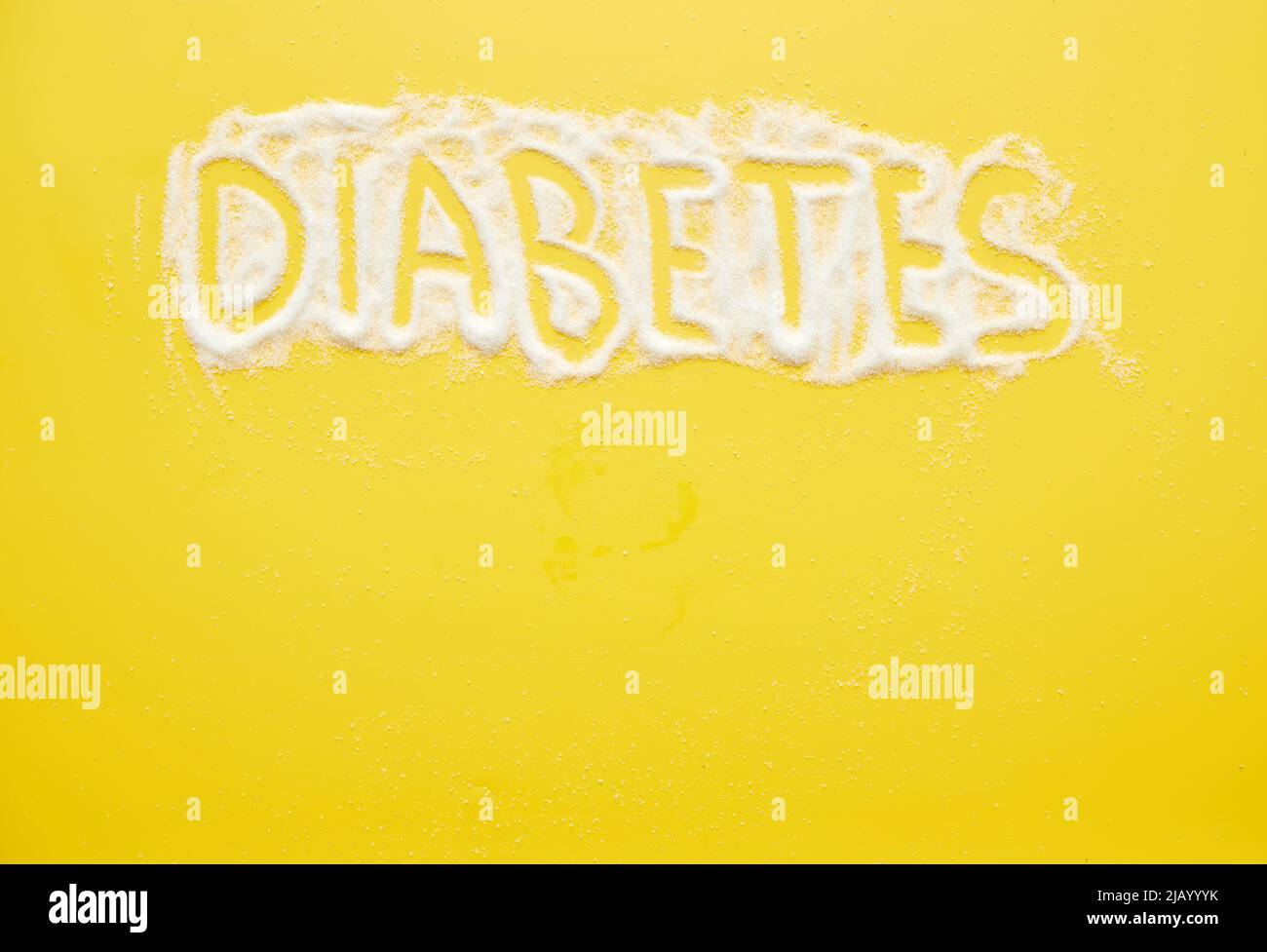 Diabetes word written on granulated sugar, bright yellow background ...