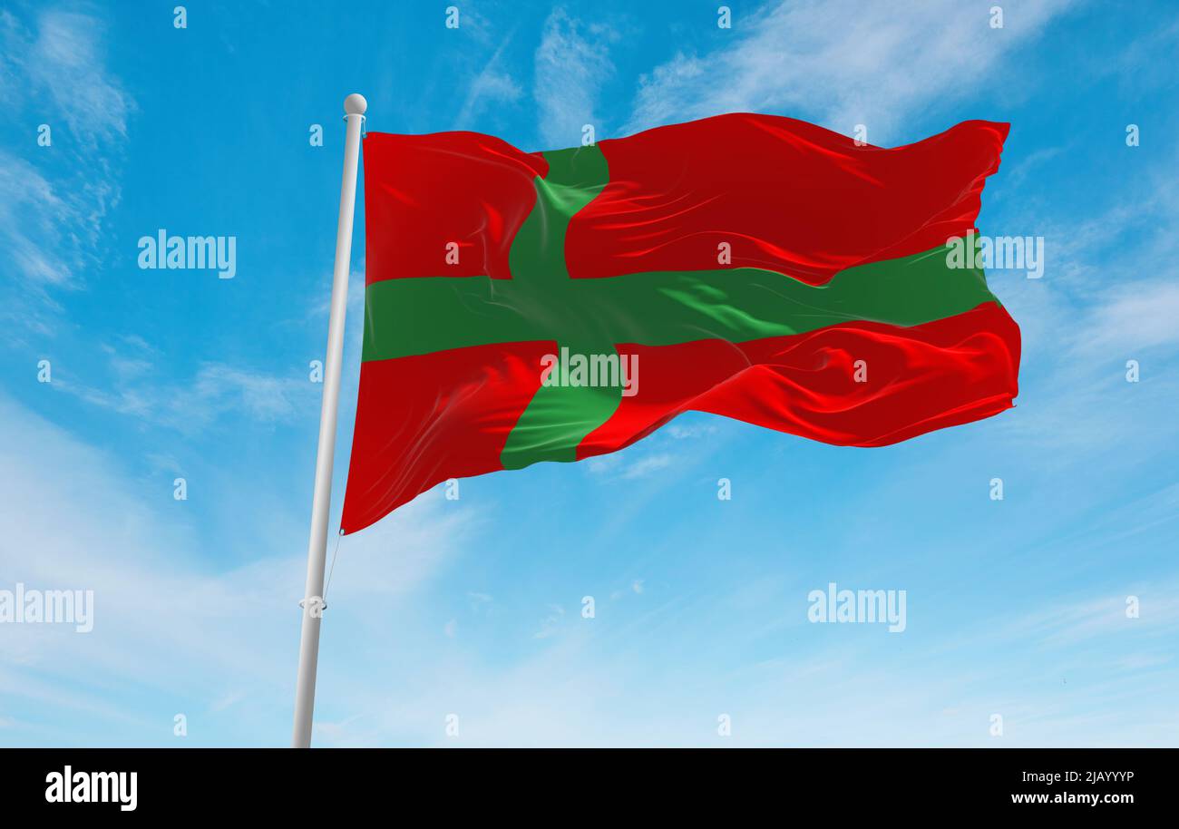 official flag of Bornholm , Denmark at cloudy sky background on sunset ...