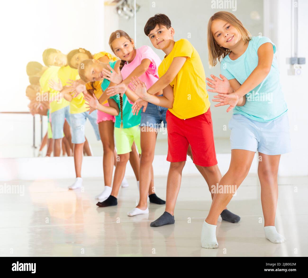 Children primary school age rehearsing movements of ballet dance in ...