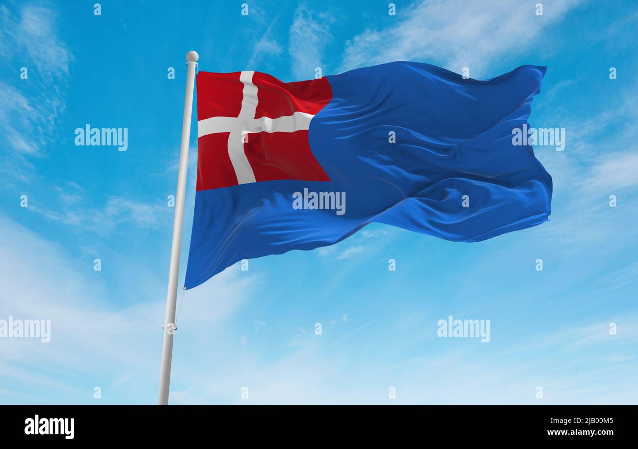 official flag of Danish blue ensign , Denmark at cloudy sky background ...
