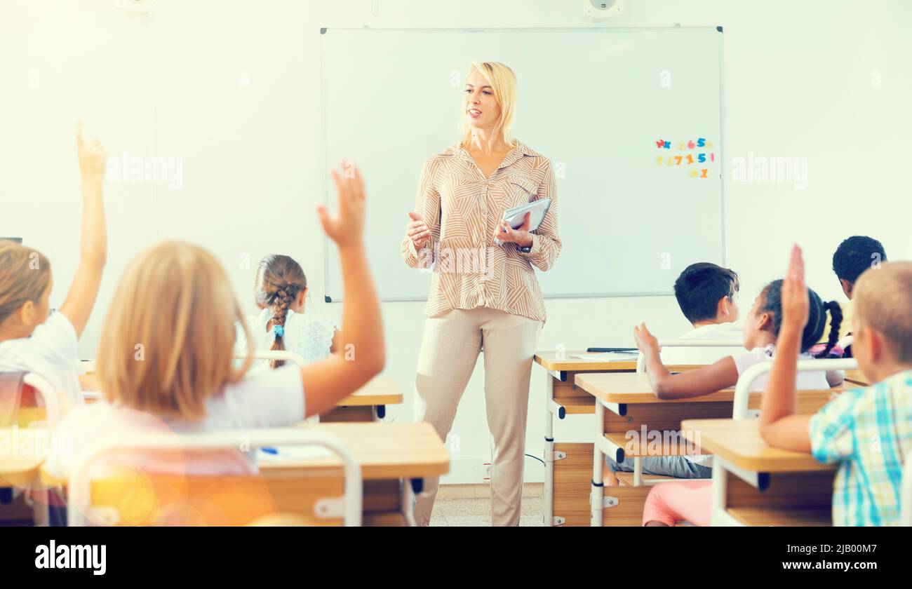 Woman teacher lecturing to pupils at classroom Stock Photo - Alamy