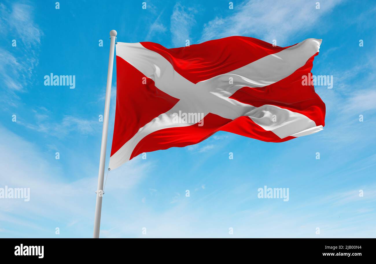 official flag of Elleore , Denmark at cloudy sky background on sunset ...