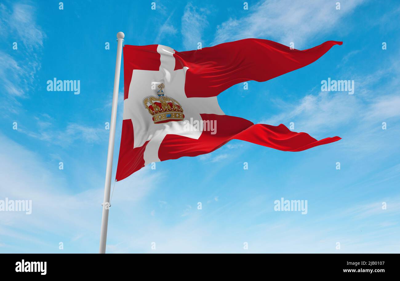 official flag of Standard Royal House , Denmark at cloudy sky ...