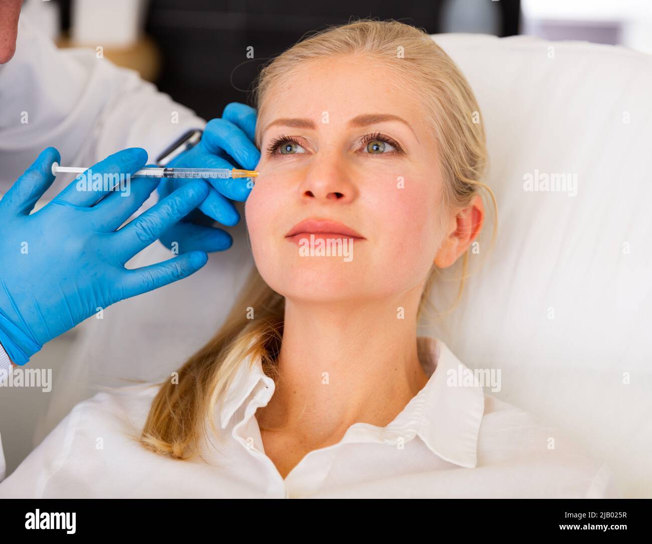 Cosmetologist doing botulotoxin injections for young woman Stock Photo ...