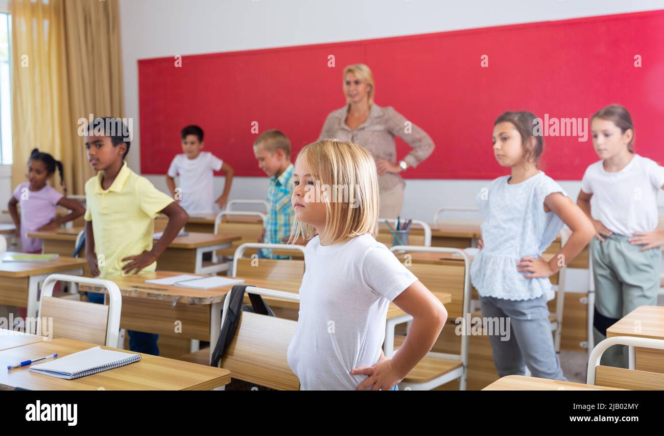 Gymnastics in classroom in elementary school Stock Photo - Alamy