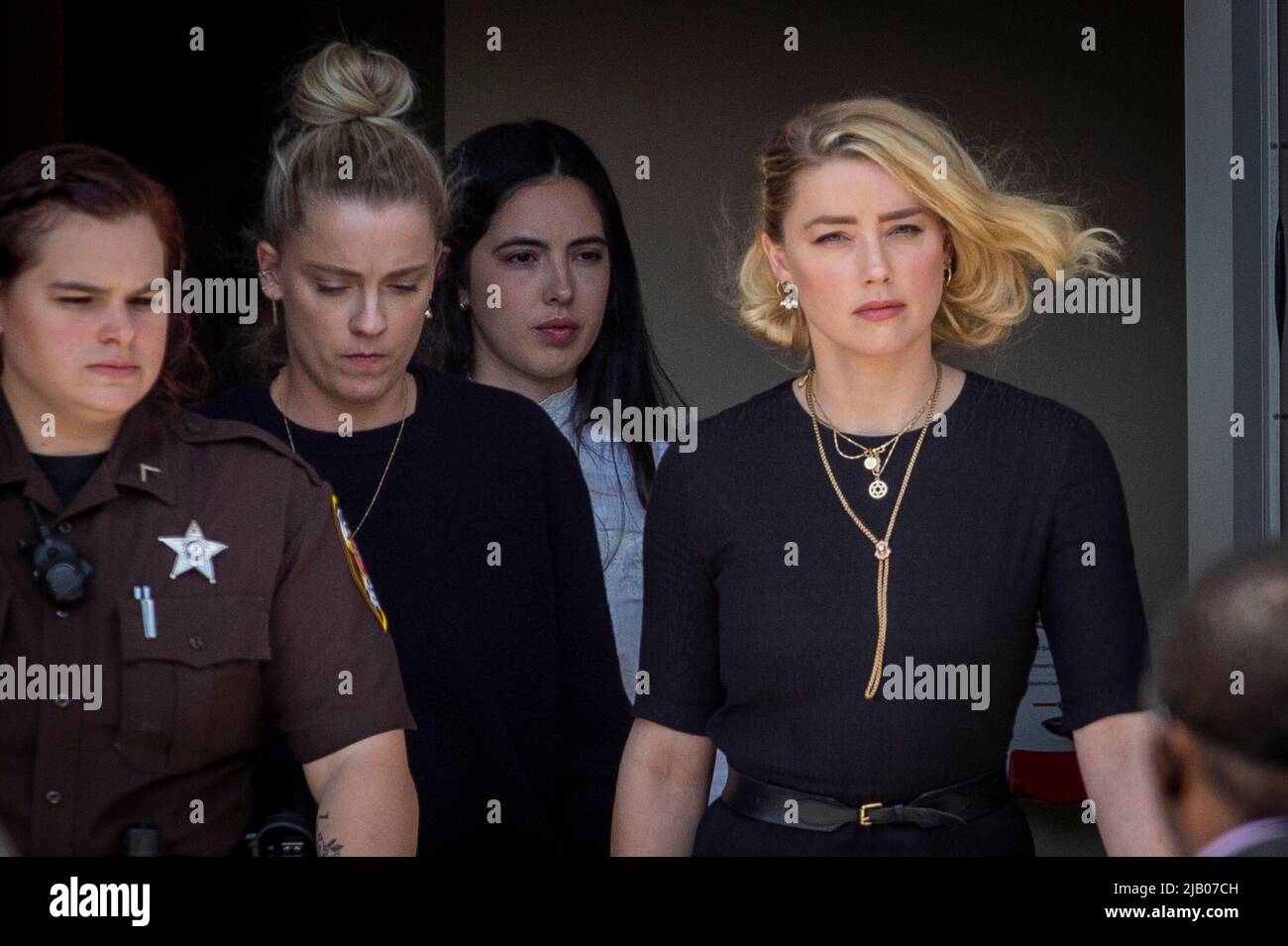 Actress Amber Heard, right, and her sister Whitney Heard, left, depart ...