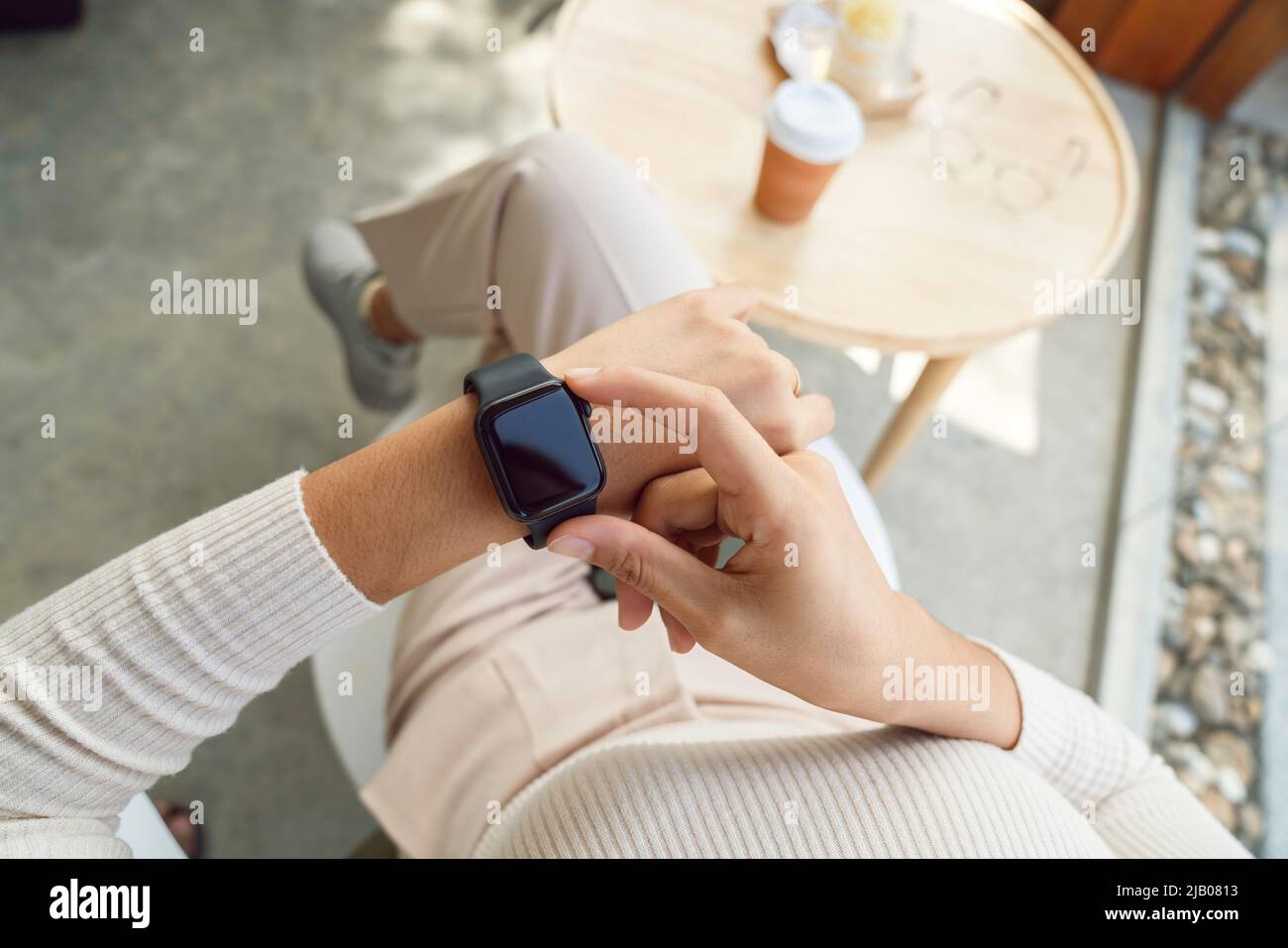 women checking smartwatch on her hand Stock Photo - Alamy