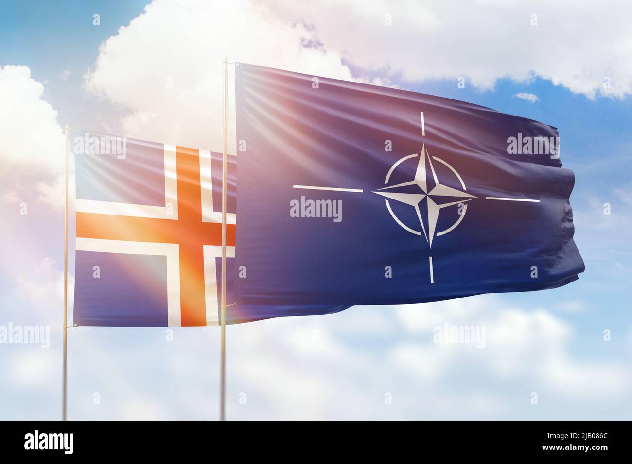 Sunny blue sky and flags of nato and iceland Stock Photo - Alamy