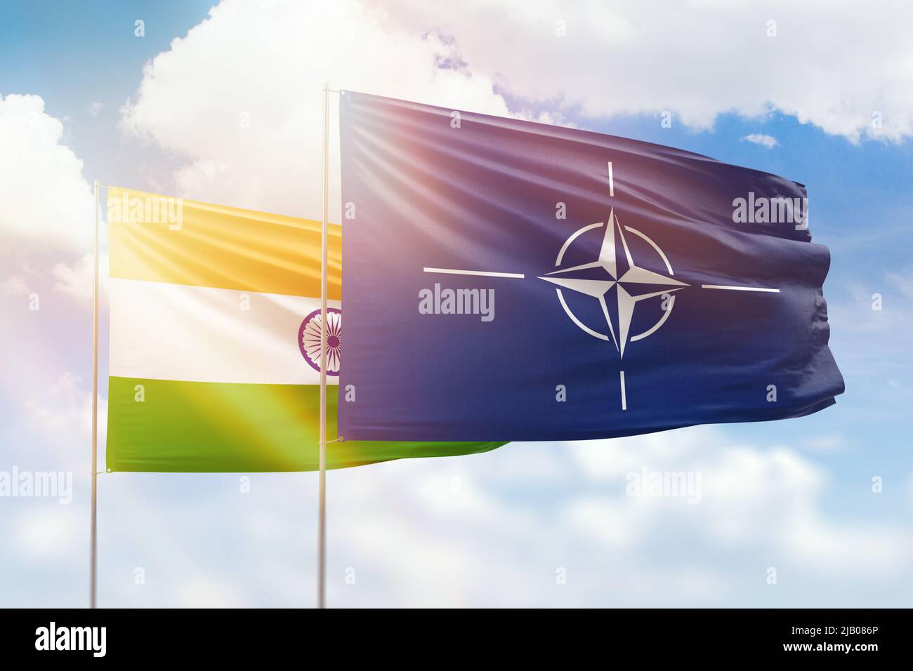 Sunny blue sky and flags of nato and india Stock Photo - Alamy